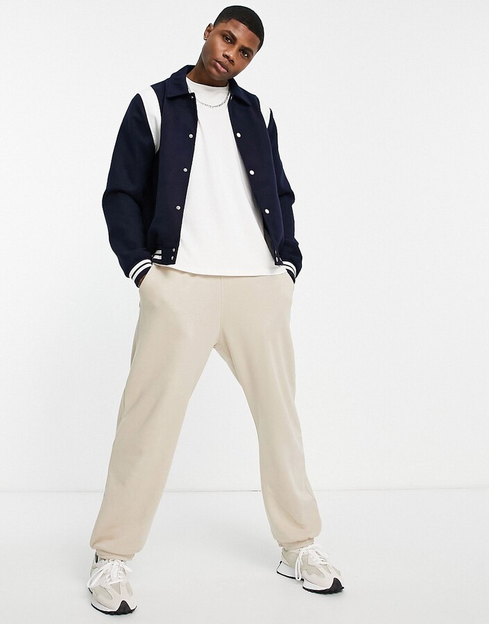 ASOS DESIGN varsity bomber jacket in navy with contrast white inserts ...